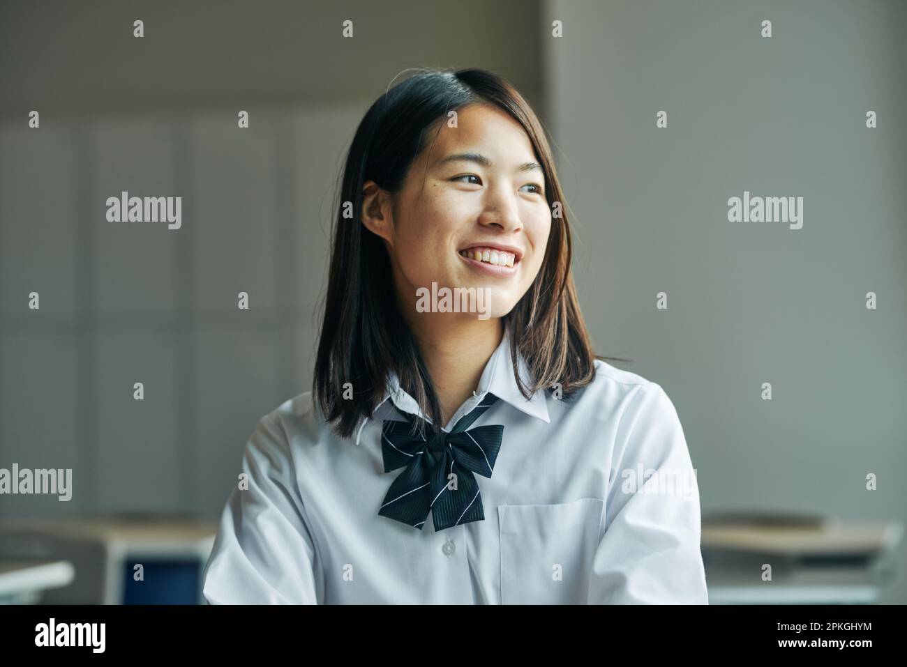 High school girls smiling in a classroom Stock Photo - Alamy