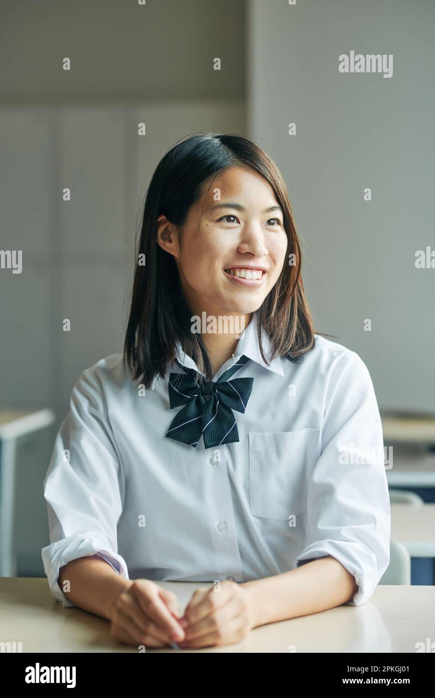 High school girls smiling in a classroom Stock Photo - Alamy
