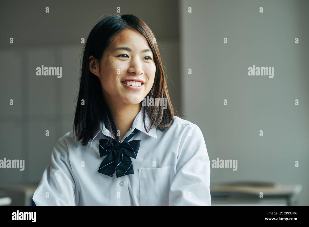 High school girls smiling in a classroom Stock Photo - Alamy