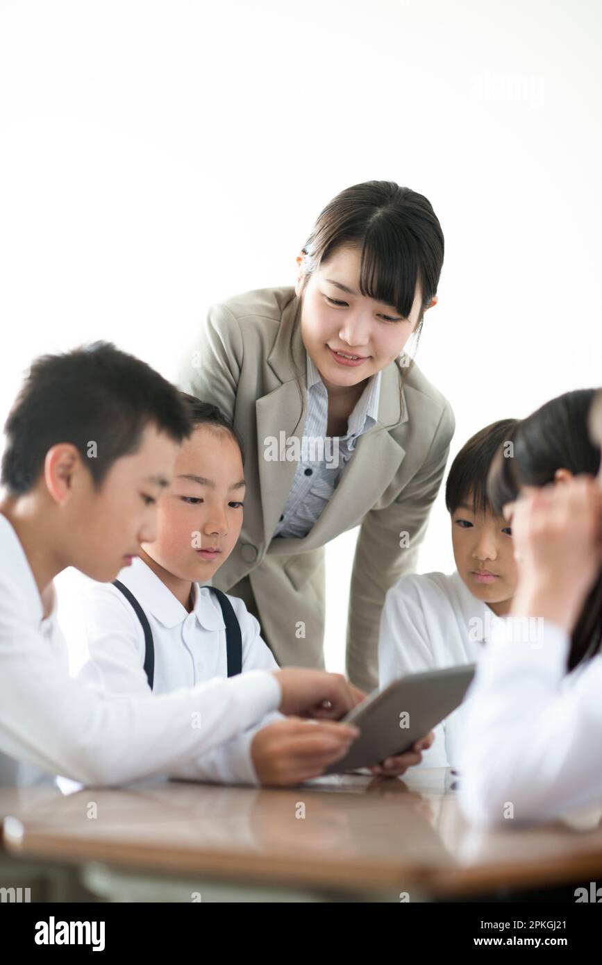 An Elementary School Student Teaching Programming to a Teacher AR Stock ...