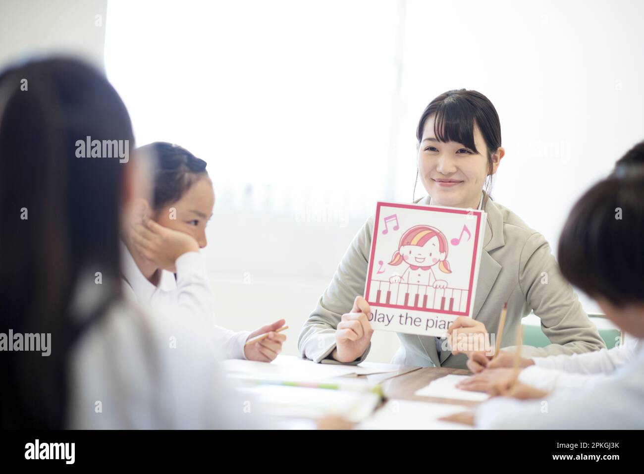 Teacher who teaches English to elementary school students Stock Photo ...