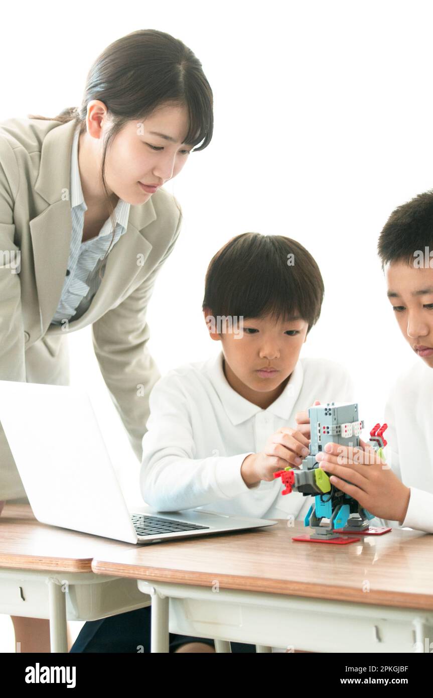 An elementary school student learning programming from his teacher ... An elementary school student learning programming from his teacher ...