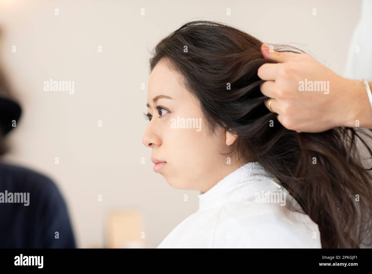Woman having her hair set by a beautician Stock Photo - Alamy