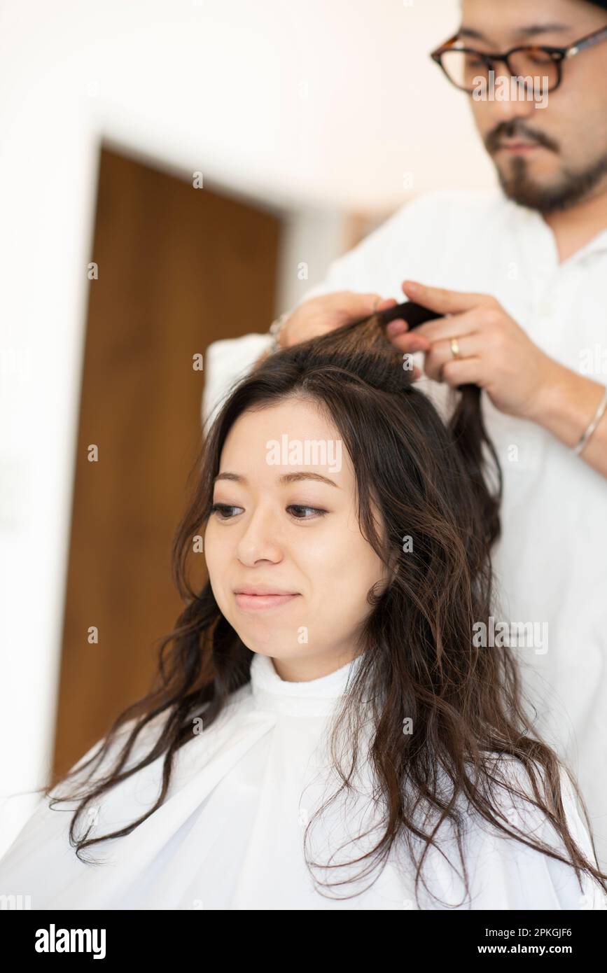 Woman having her hair set by a beautician Stock Photo - Alamy