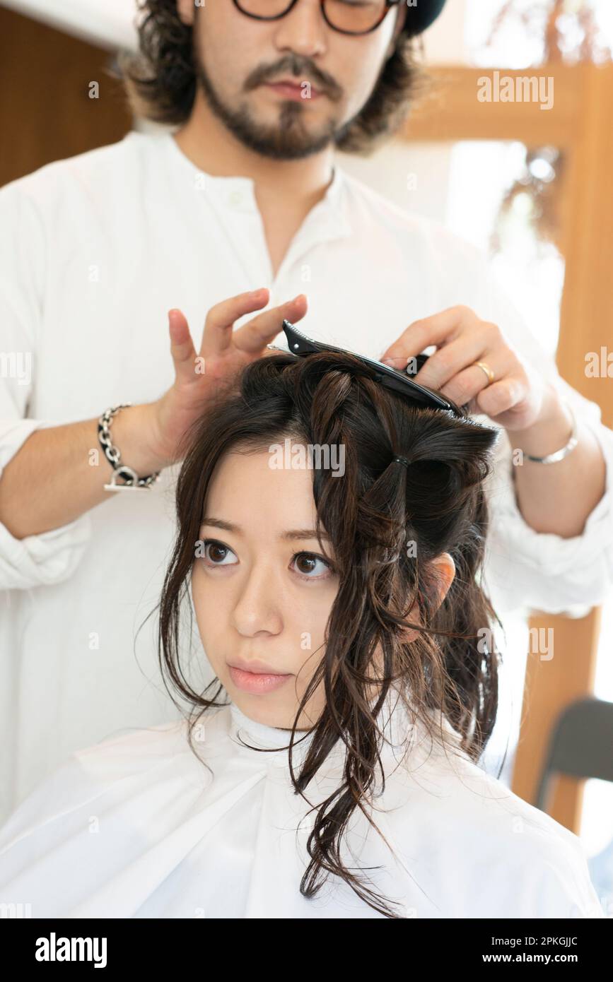 Woman having her hair set by a beautician Stock Photo - Alamy