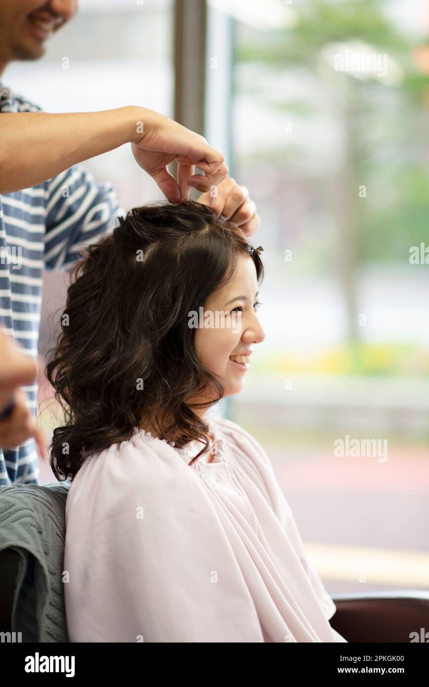 Woman having her hair set by a beautician Stock Photo - Alamy