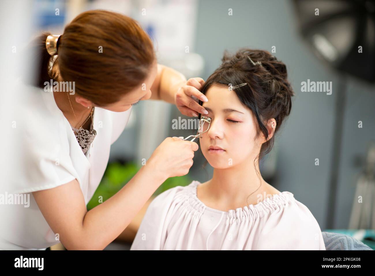 Woman getting makeup done Stock Photo - Alamy