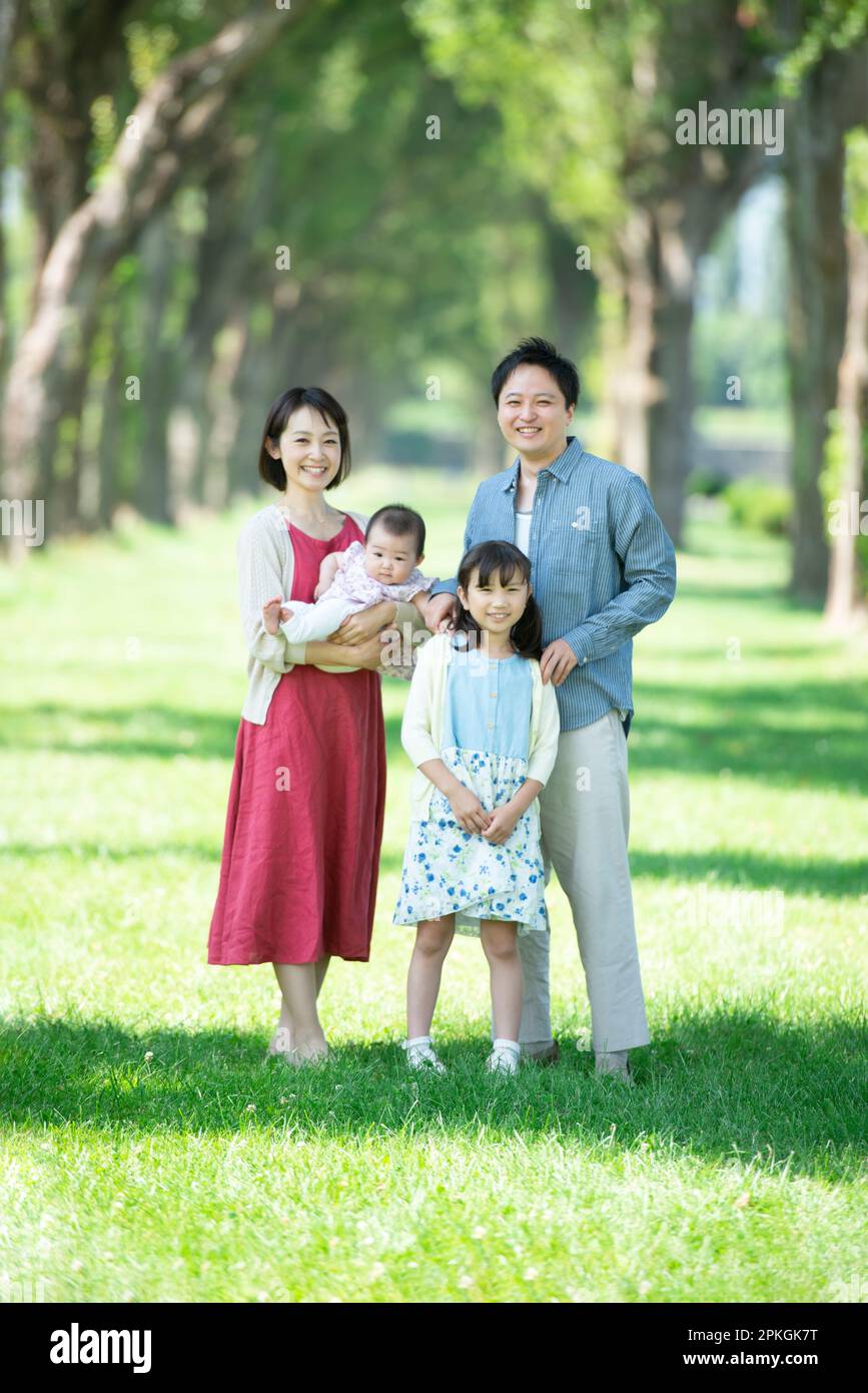 Family smiling at a row of poplar trees Stock Photo - Alamy