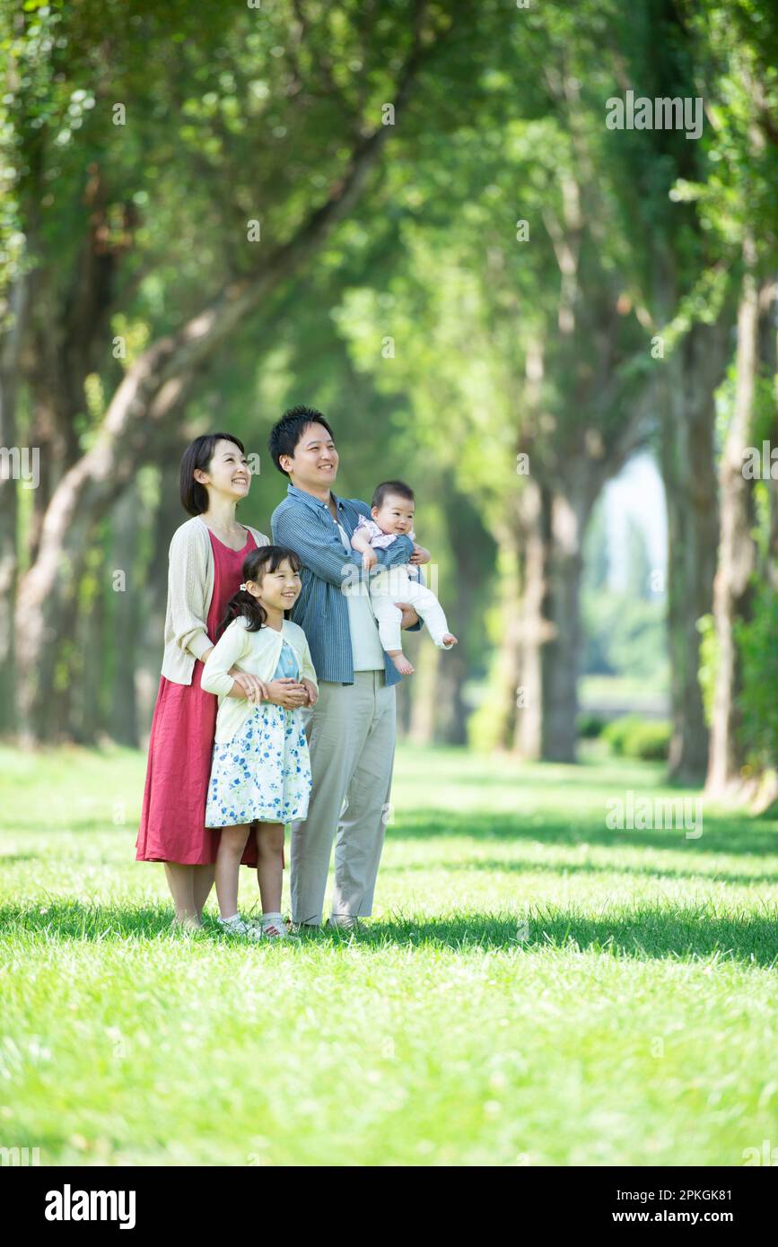 Family smiling at a row of poplar trees Stock Photo - Alamy