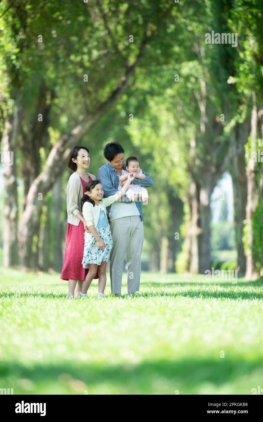 Family smiling at a row of poplar trees Stock Photo - Alamy