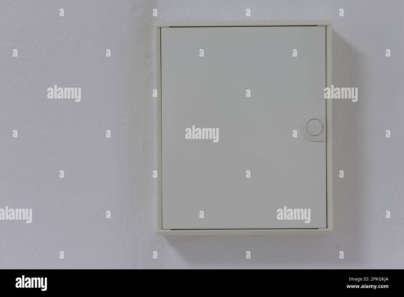 White fuse box closed on the wall Stock Photo - Alamy