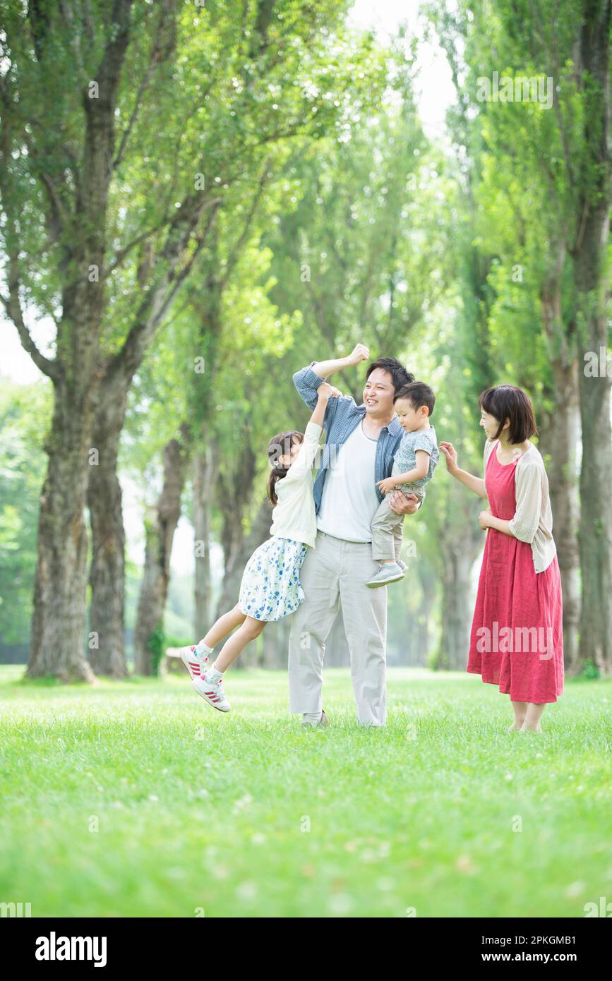 Parent and child playing at poplar-lined avenue of trees Stock Photo ...