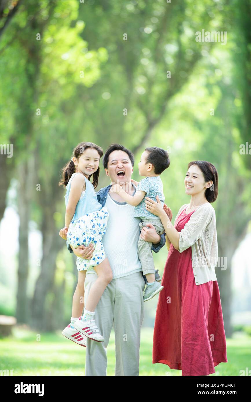 Family smiling at poplar trees Stock Photo - Alamy