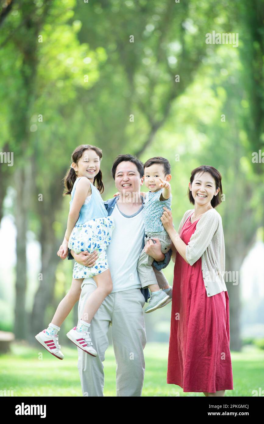 Family smiling at poplar trees Stock Photo - Alamy