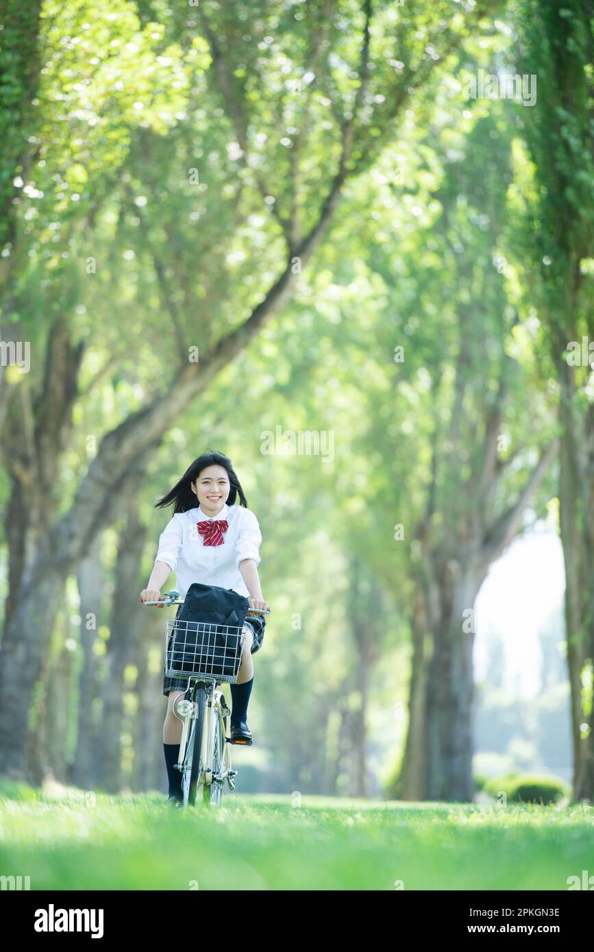Schoolgirl riding a bicycle hi-res stock photography and images - Alamy