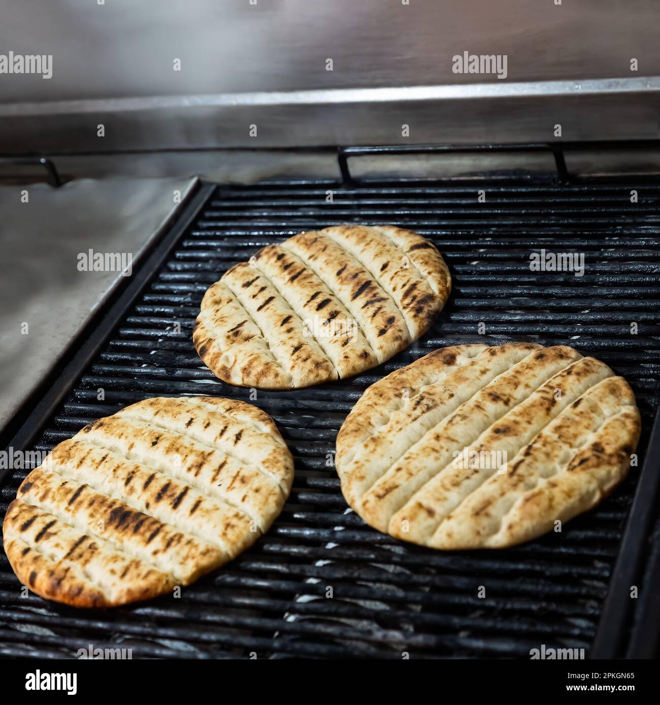 Homemade pita bread a traditional Greek wrap sandwich baked on grill ...