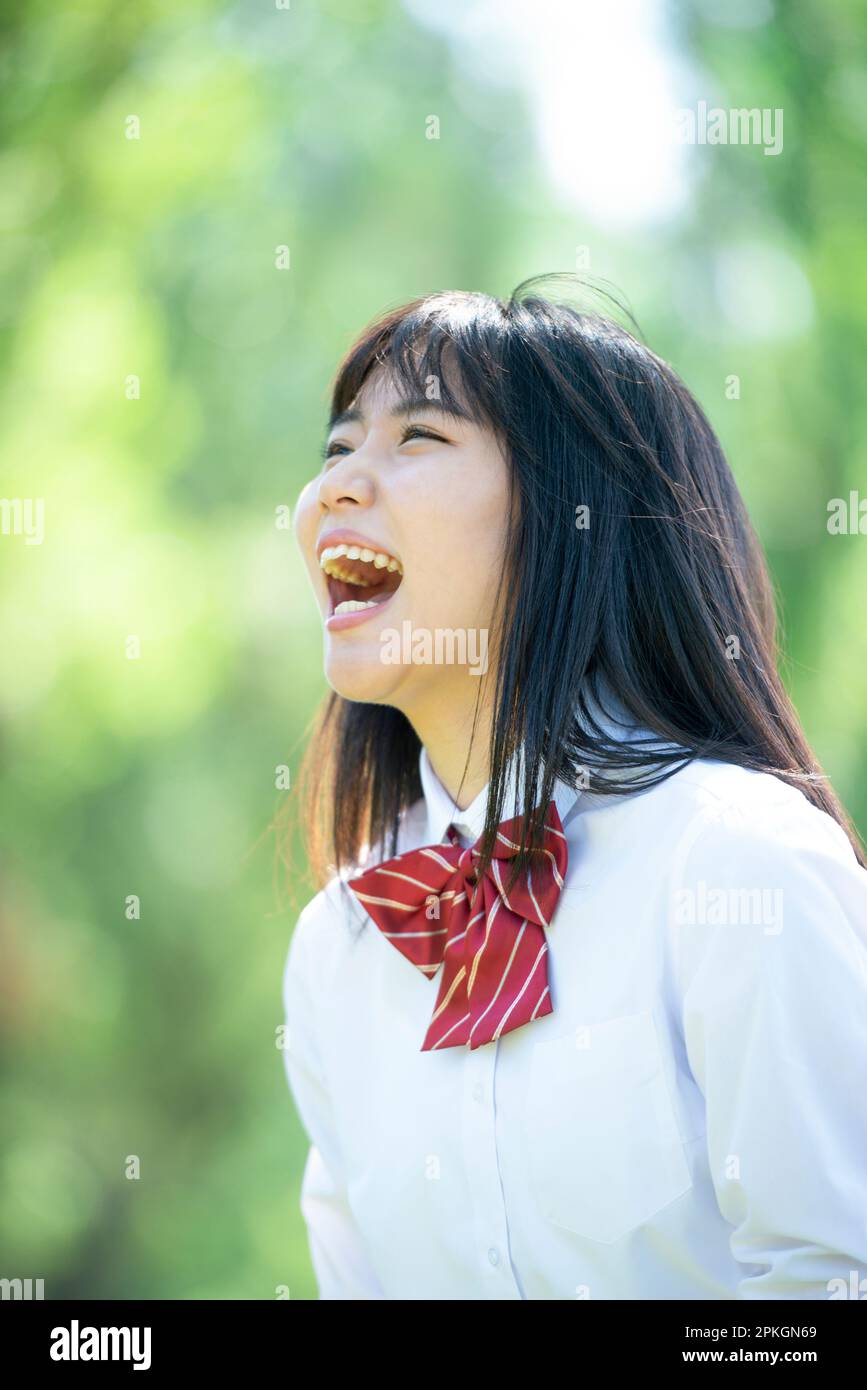 Female student shouting on a poplar tree lined with poplar trees Stock ...