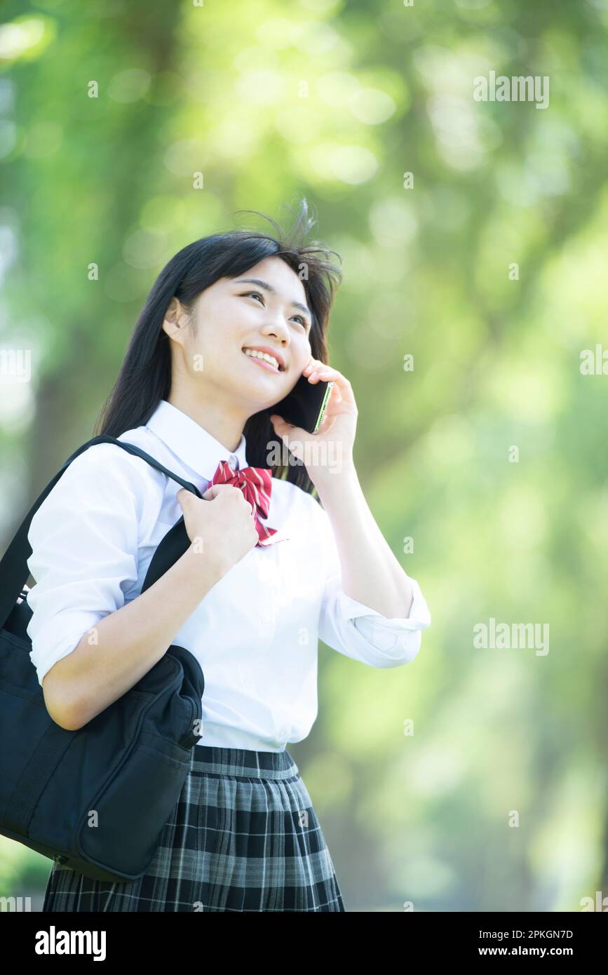 Female student making a phone call with a smartphone Stock Photo - Alamy
