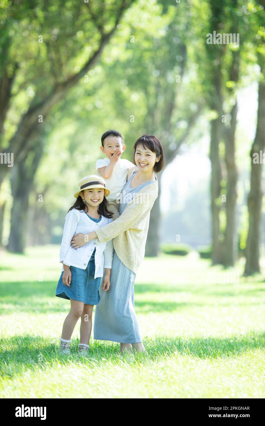 Parent and child smiling at row of poplar trees Stock Photo - Alamy