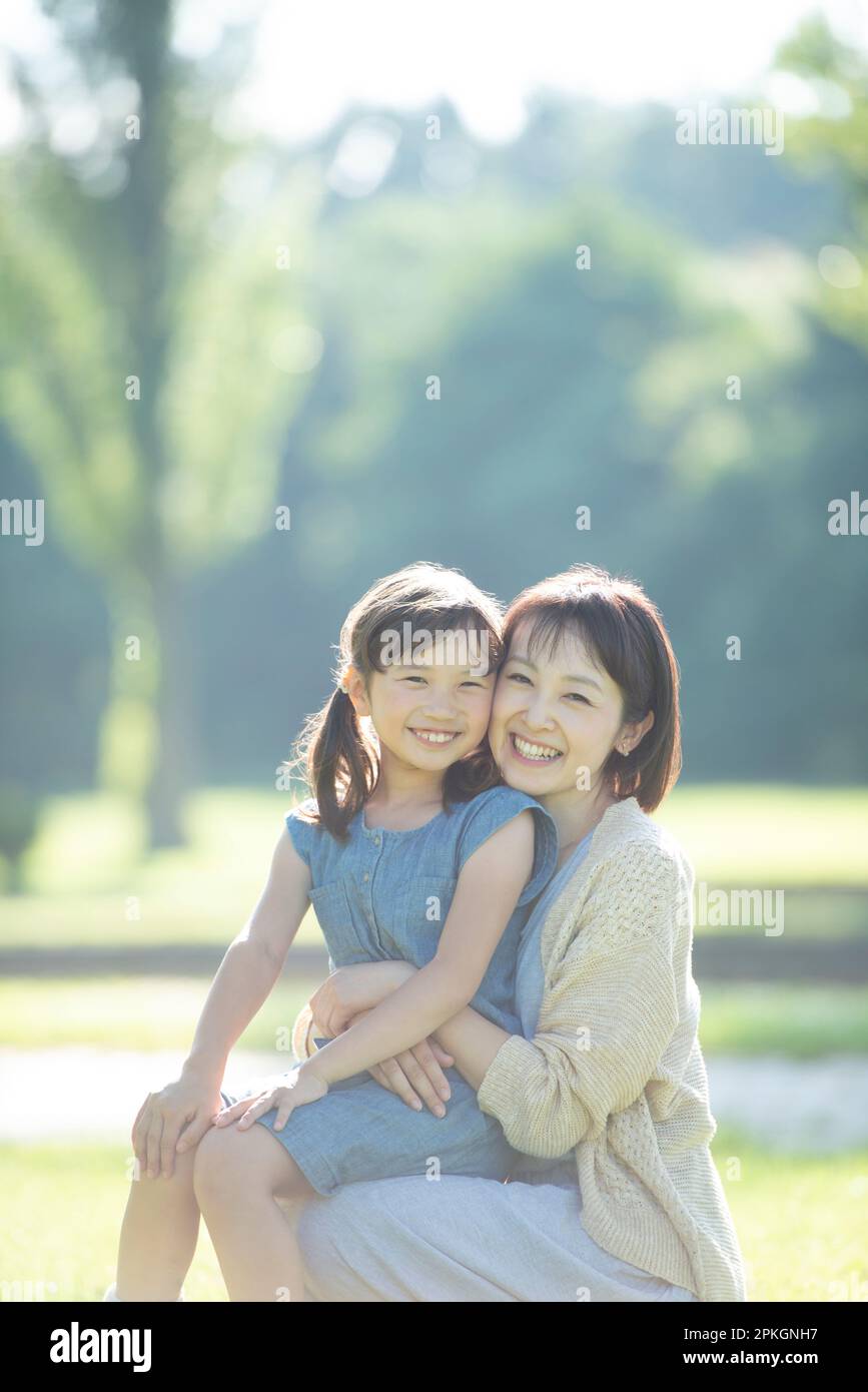 Smiling parents and children in the park Stock Photo - Alamy