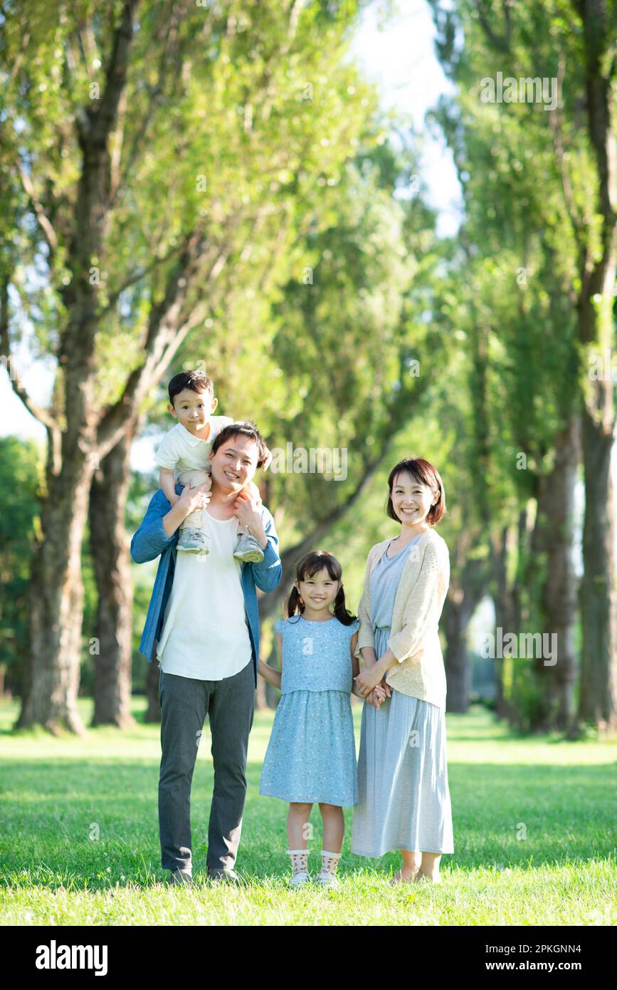 Family smiling at a row of poplar trees Stock Photo - Alamy