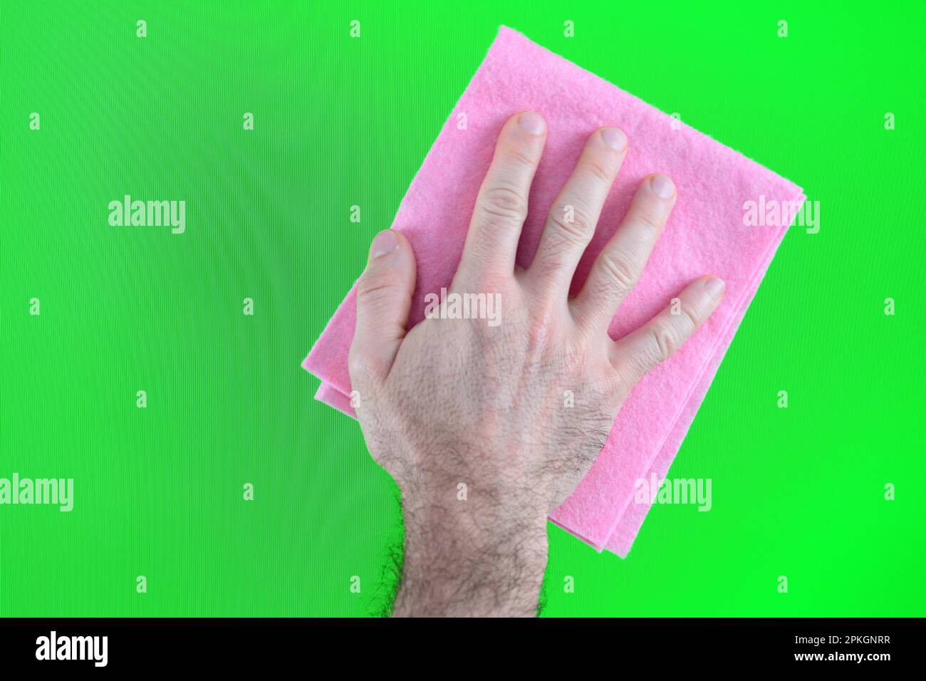 Closeup male hand holding pink duster microfiber cloth for cleaning ...