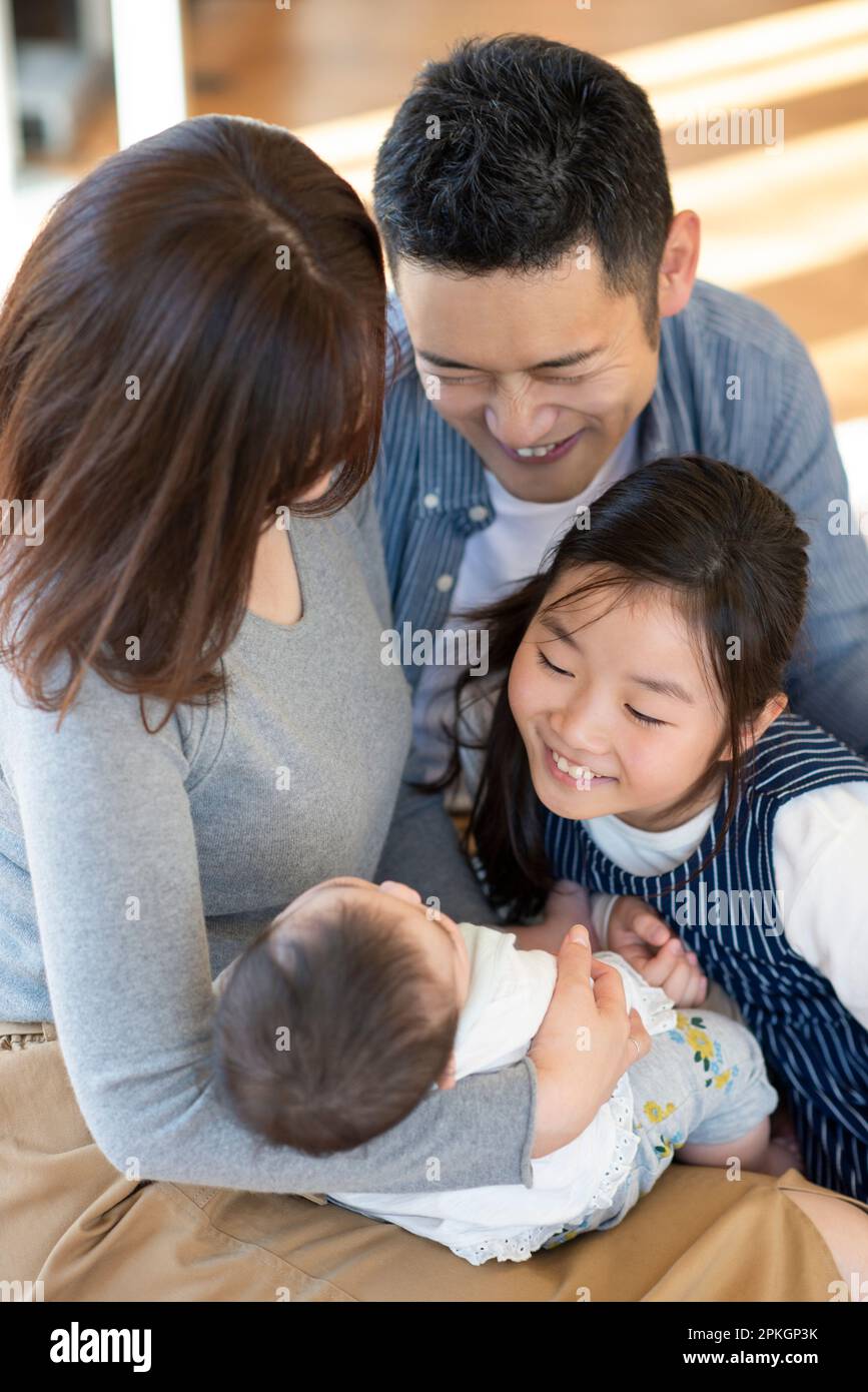 Family watching over baby Stock Photo - Alamy