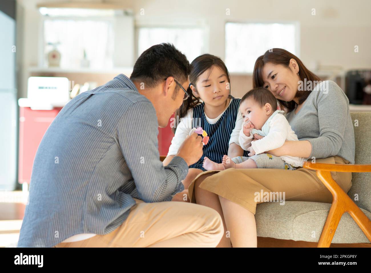 Family chatting with baby Stock Photo - Alamy