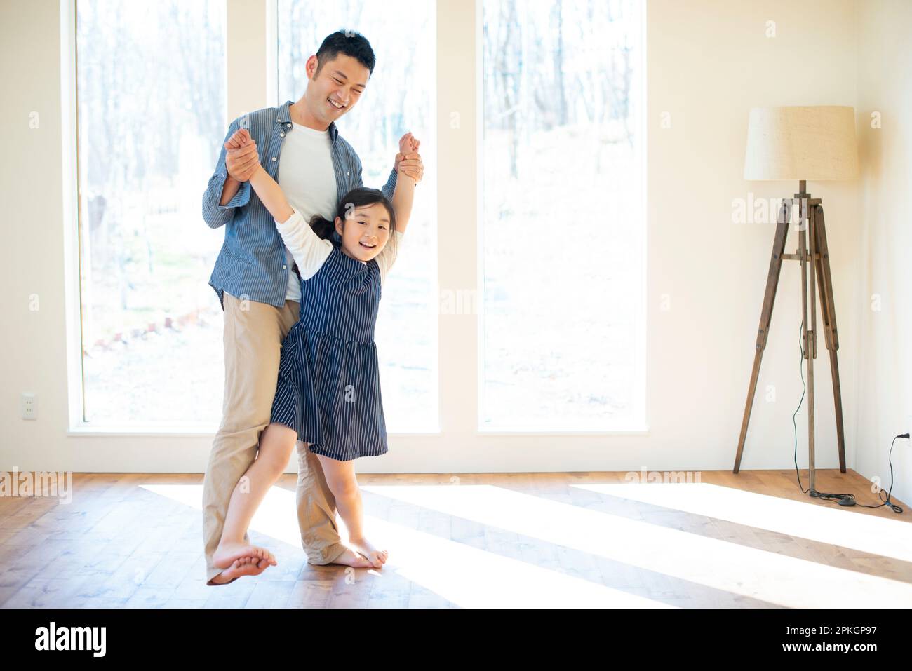 Parents and children playing inside a house Stock Photo - Alamy