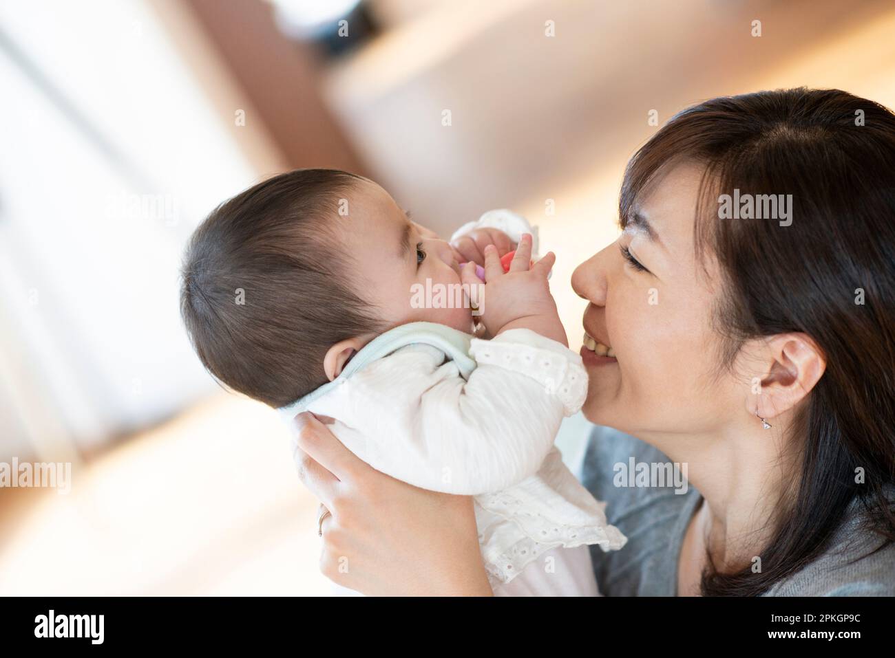 Mother baby smiling looking profile hi-res stock photography and images ...