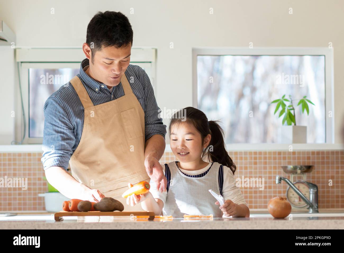 Parent and child cooking in kitchen Stock Photo - Alamy