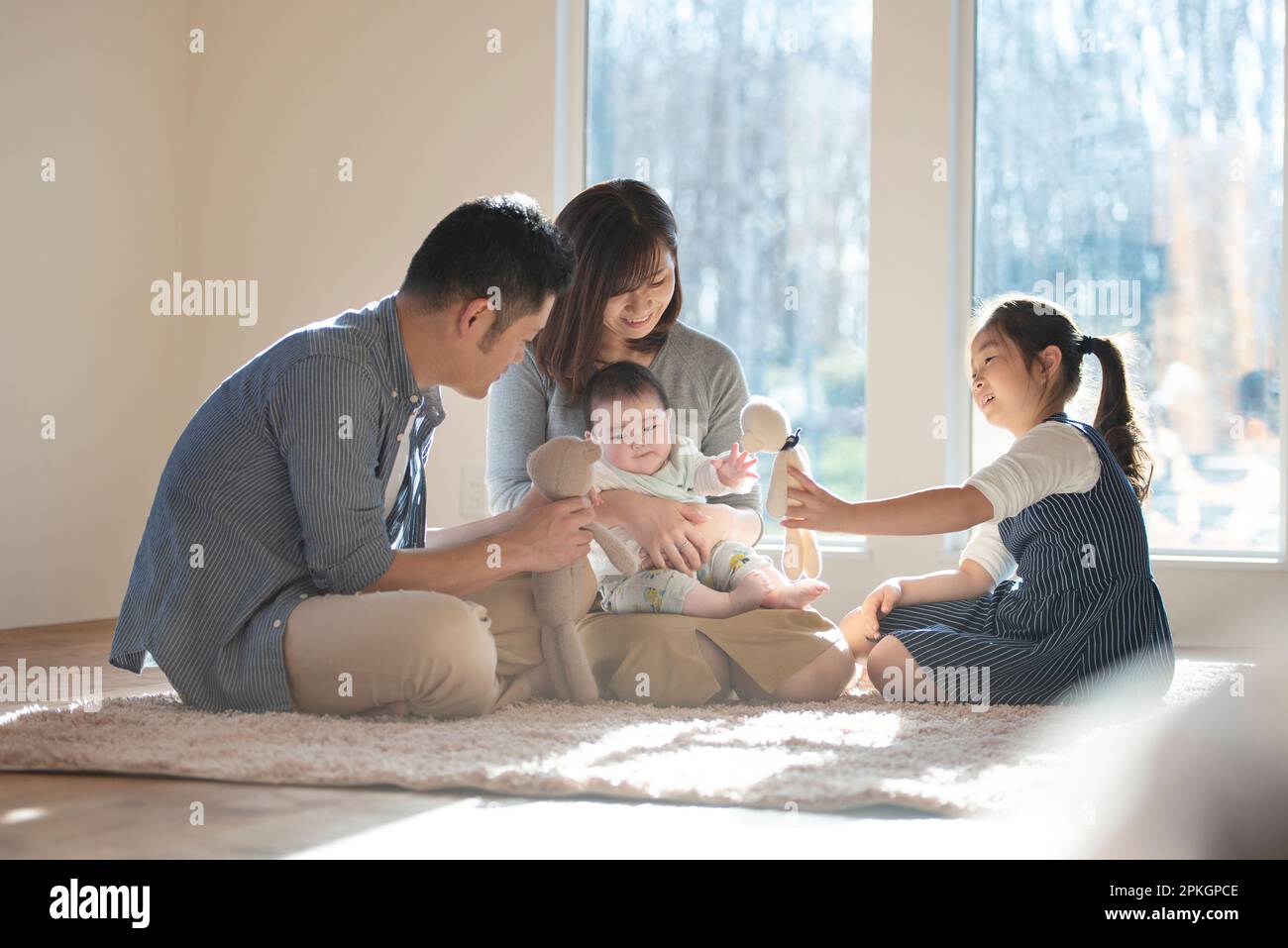 Family chatting around baby Stock Photo - Alamy