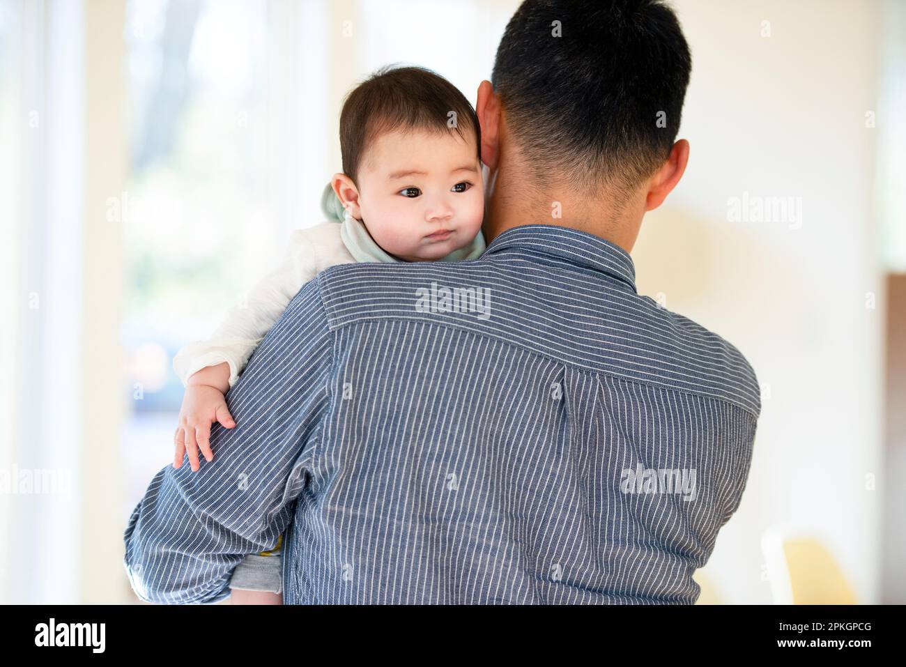 Asian father hugging baby hi-res stock photography and images - Alamy