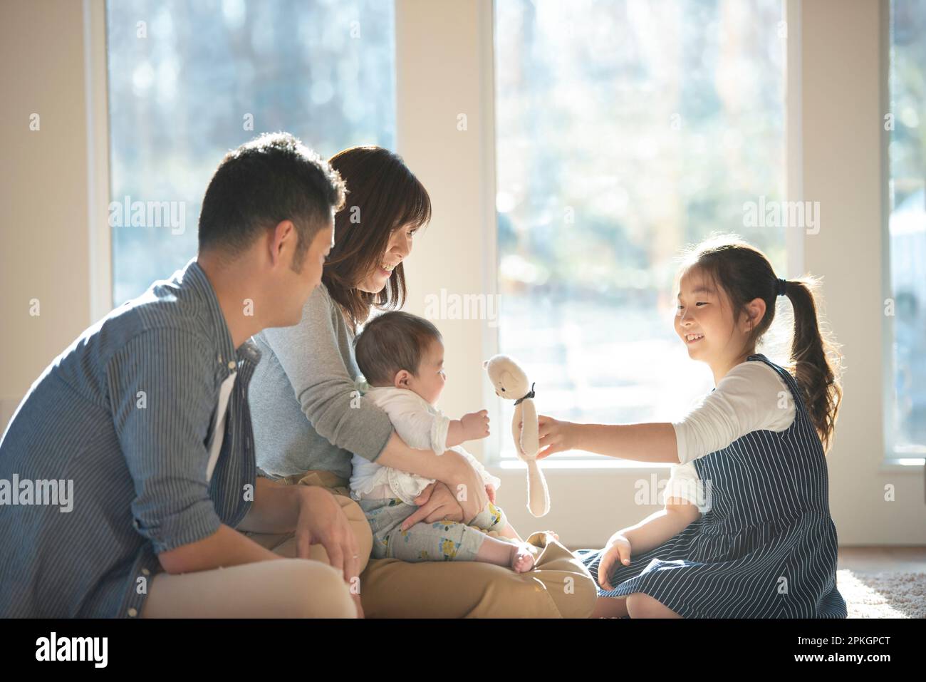 Family chatting with baby Stock Photo - Alamy