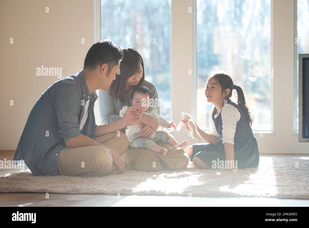 Family chatting around baby Stock Photo - Alamy