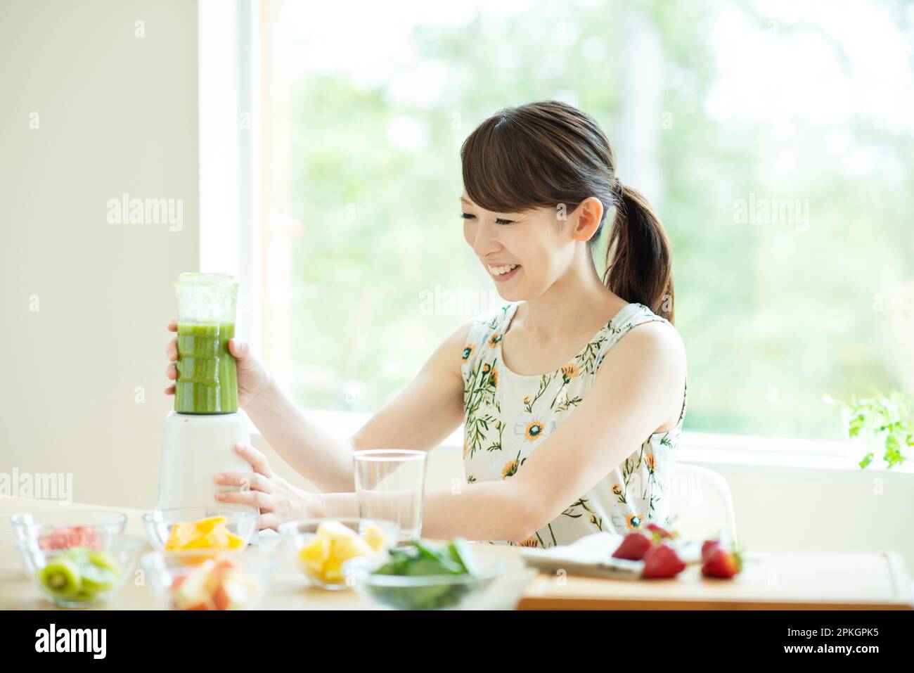 Woman making a smoothie Stock Photo - Alamy
