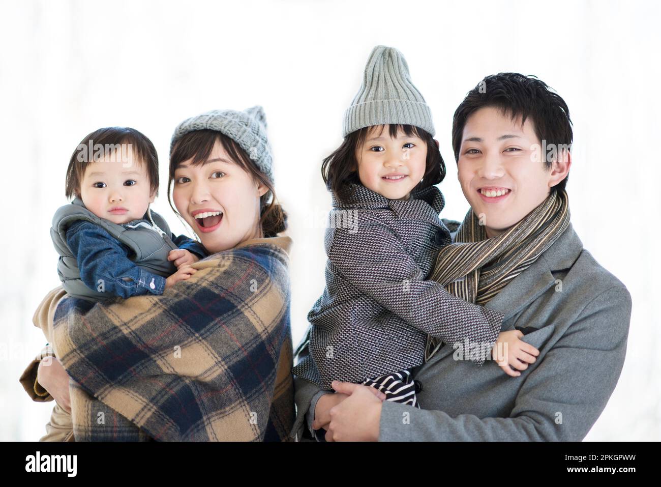 Family smiling as they hold their child Stock Photo - Alamy