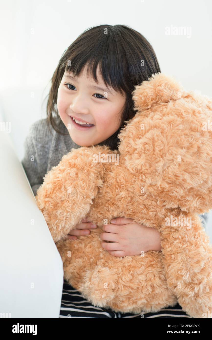 Smiling girl holding stuffed bear Stock Photo - Alamy