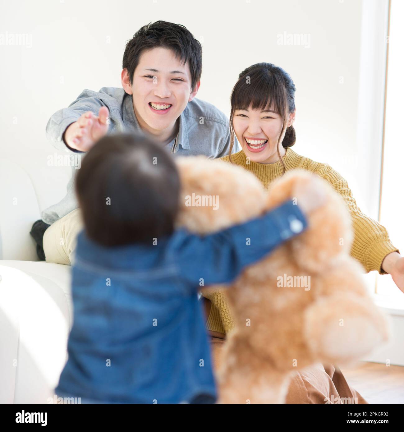 Boy Running to Parents Stock Photo - Alamy