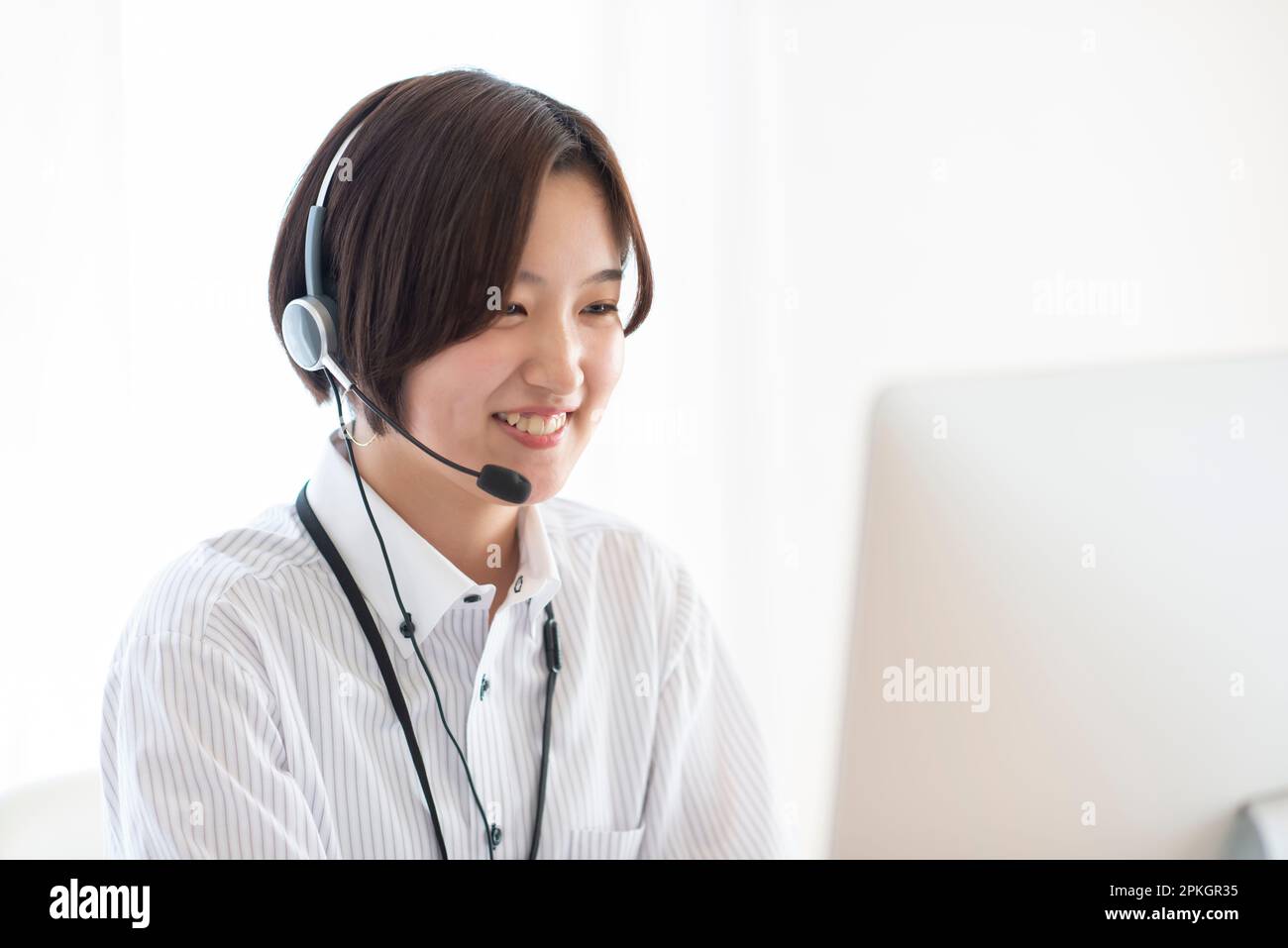 Smiling female operator Stock Photo - Alamy