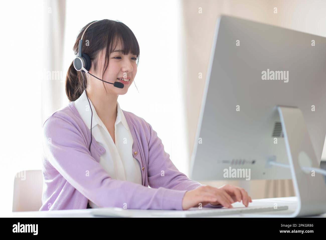 Smiling Female Operator Stock Photo - Alamy