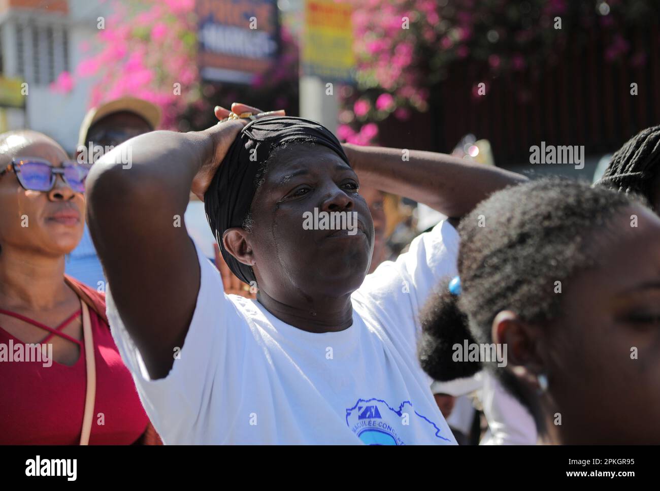 A woman reacts during the re-enactment of the crucifixion of Jesus ...