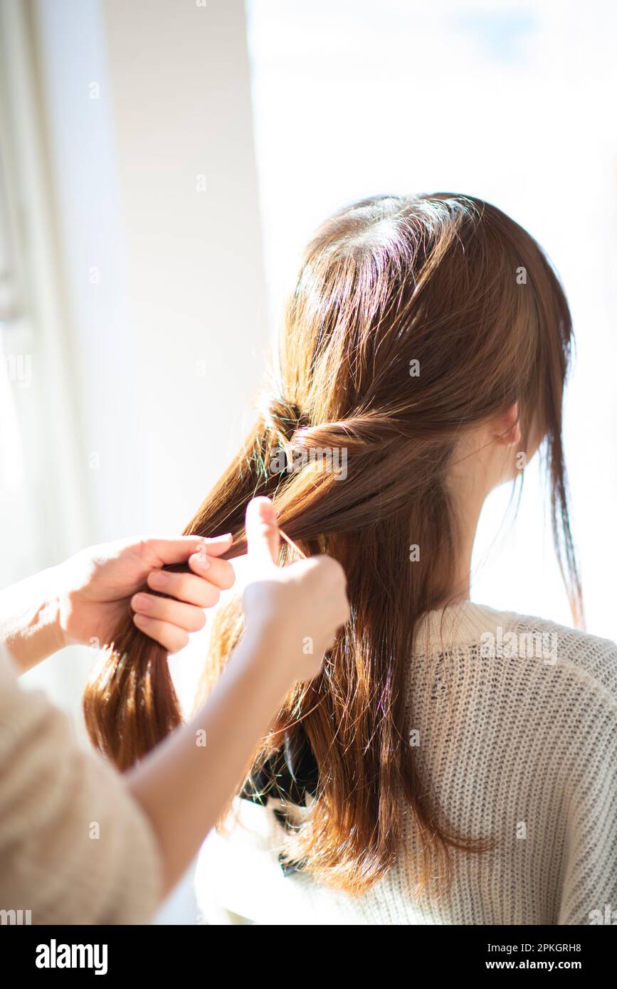 Woman Tying Hair Back Stock Photo - Alamy