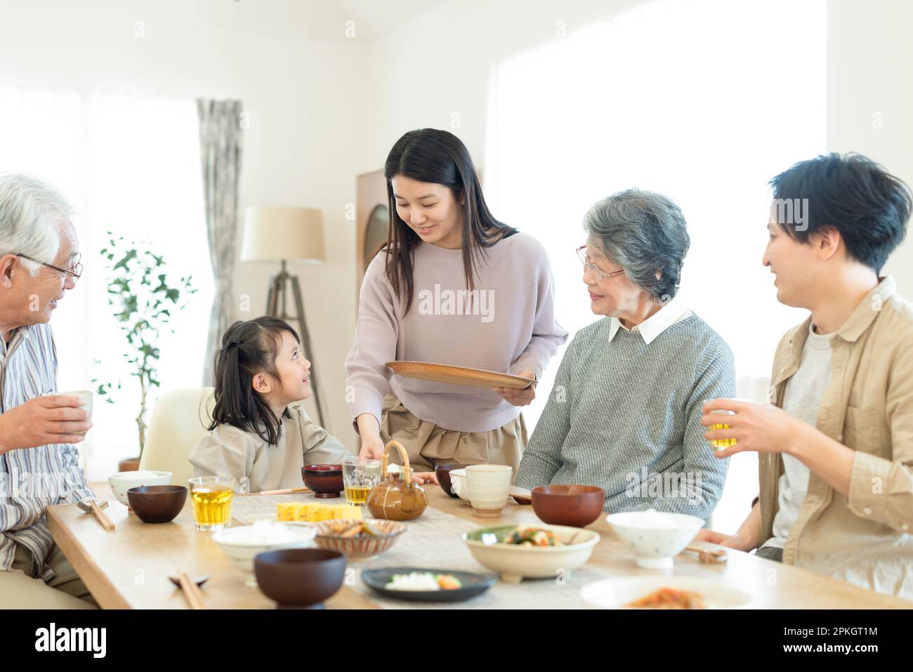 A family of three eating breakfast Stock Photo - Alamy