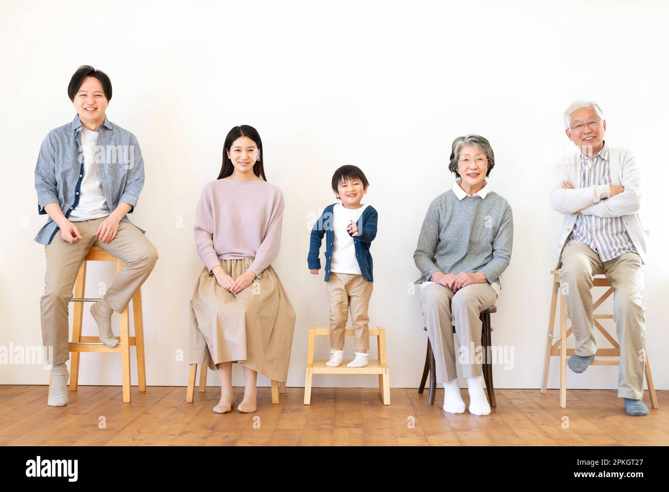 Family of 3 generations sitting on a chair and smiling Stock Photo - Alamy