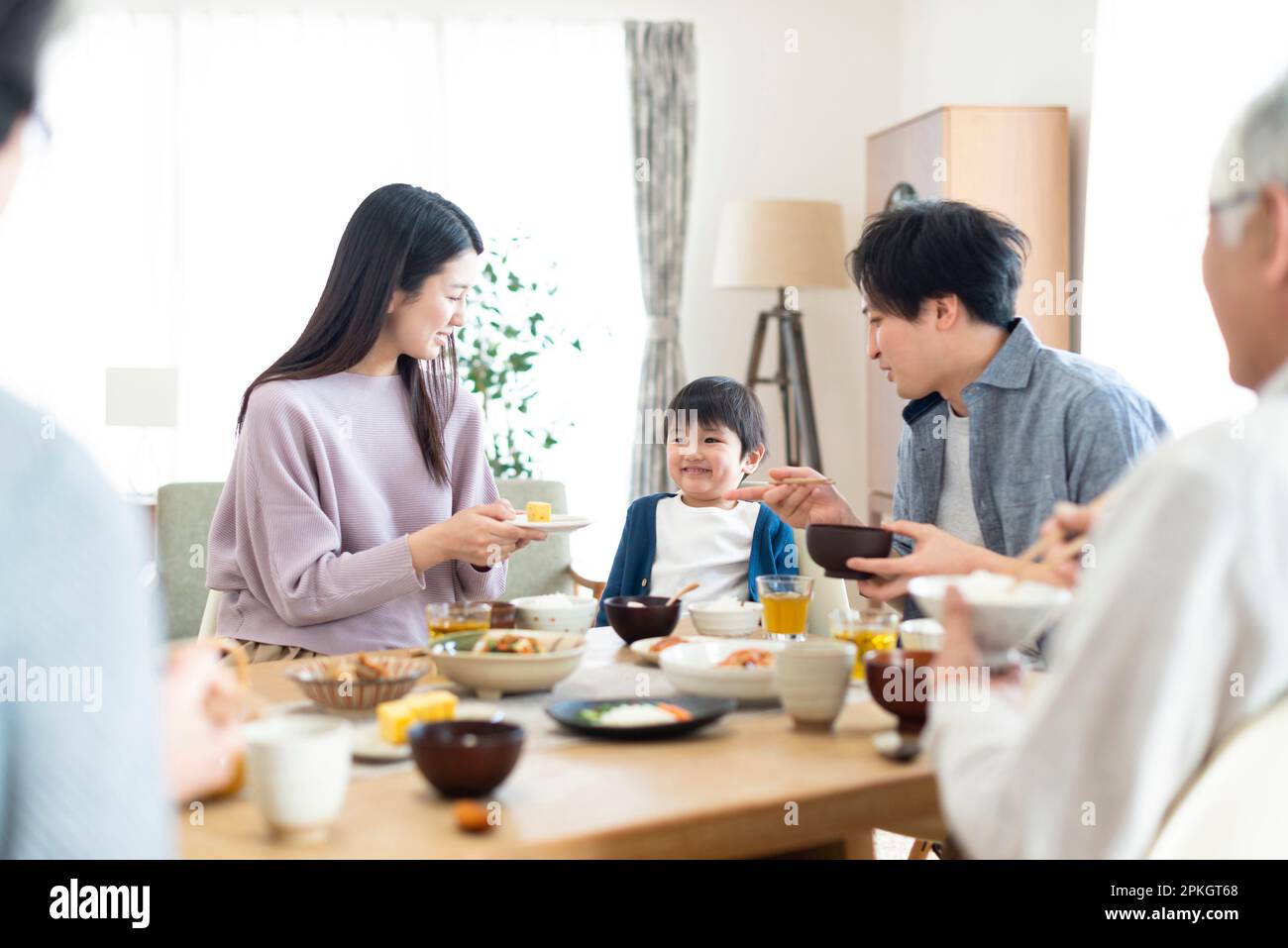 Three-generation family eating breakfast Stock Photo - Alamy
