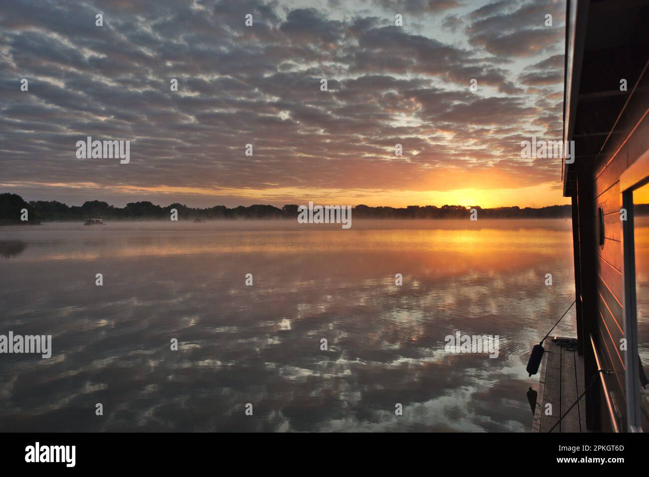 Sun rise on a house boat on a lake Stock Photo - Alamy