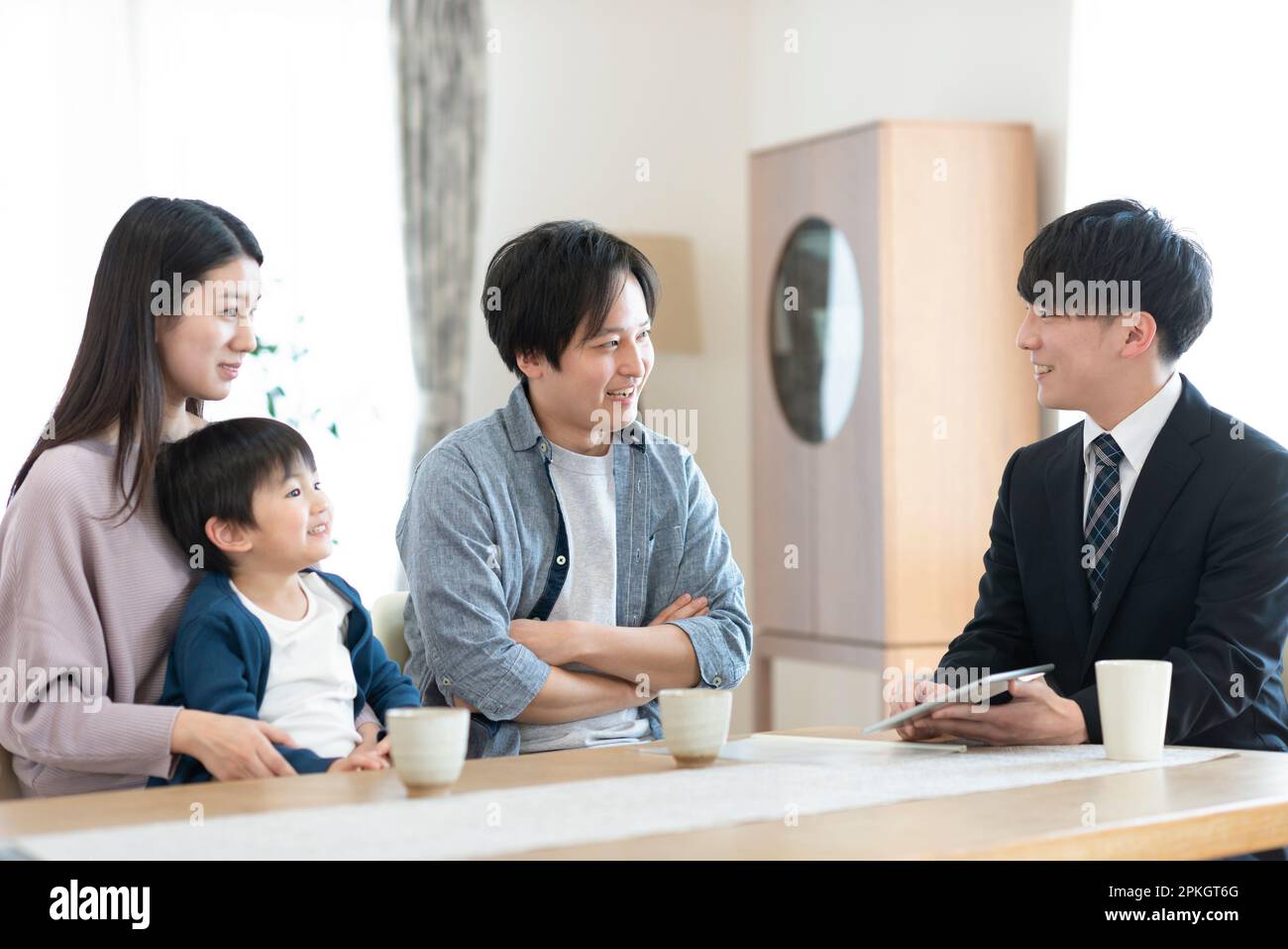 Family Talking with Businessman Stock Photo - Alamy