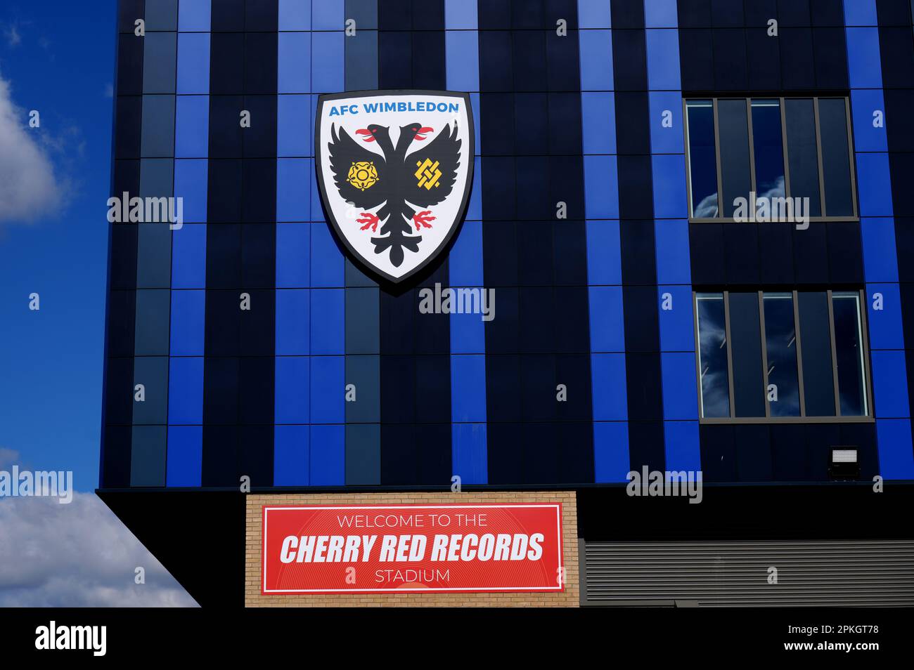 The AFC Wimbledon club badge at the Cherry Red Records Stadium, London ...