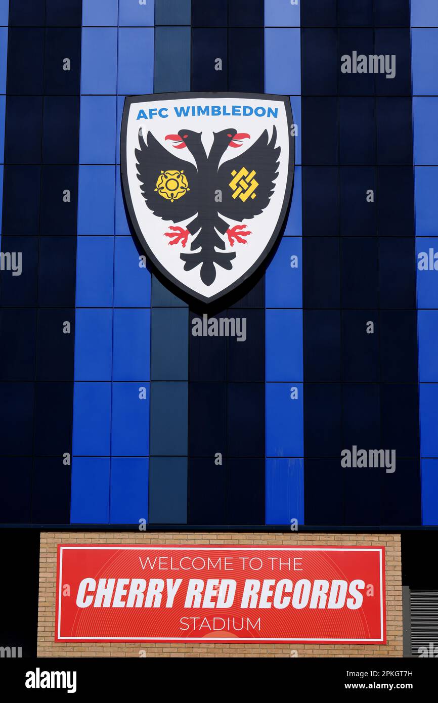 The AFC Wimbledon club badge at the Cherry Red Records Stadium, London ... The AFC Wimbledon club badge at the Cherry Red Records Stadium, London ...